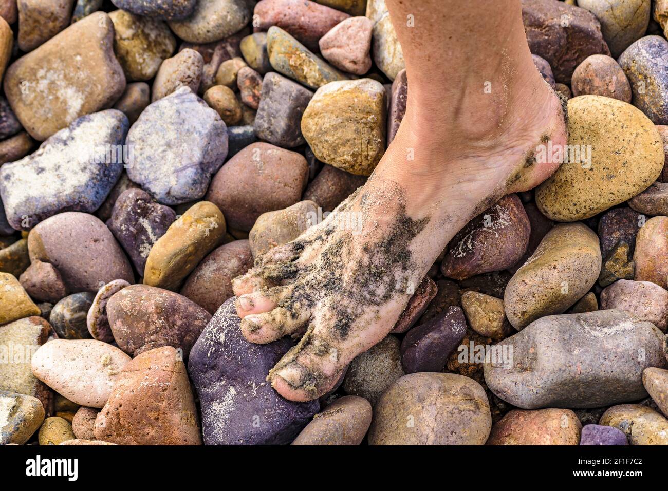 Woman Foot at Rocky Ground Stock Photo - Alamy