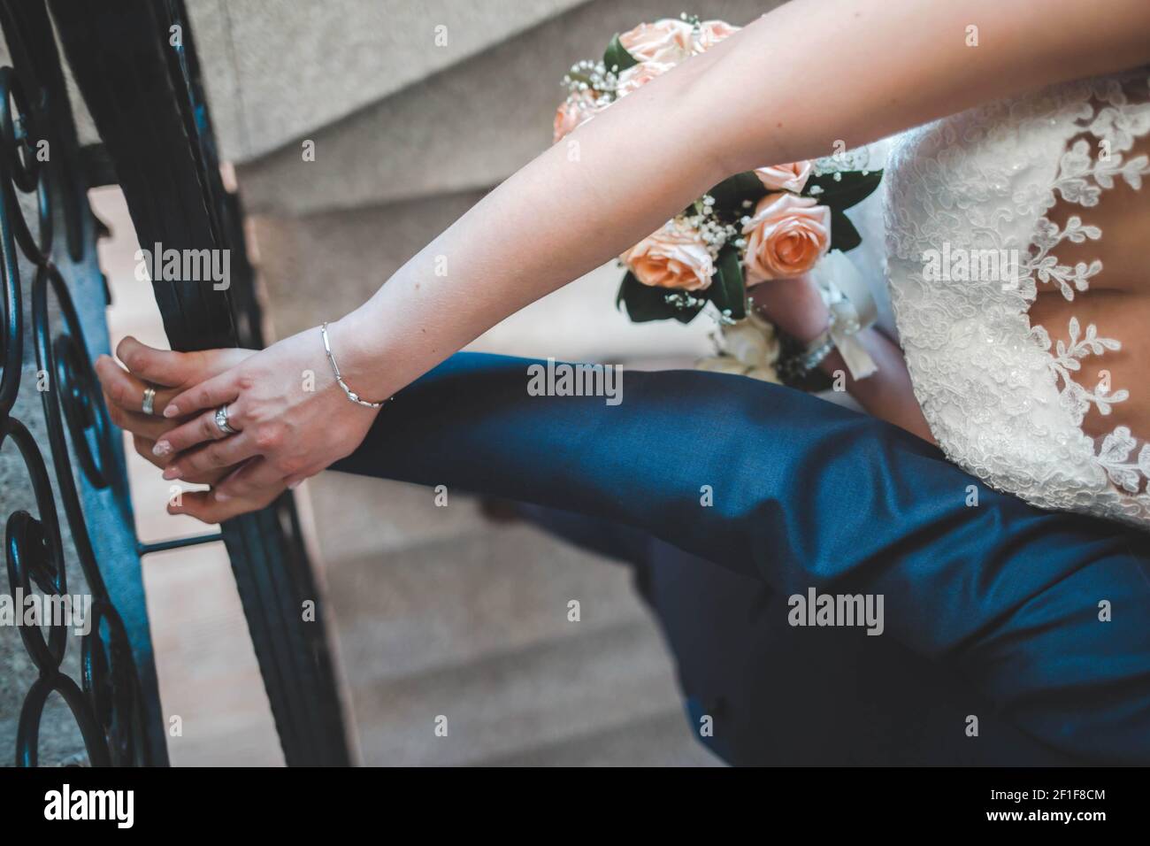 A high angle shot of a newly married couple holding hands and showing ...