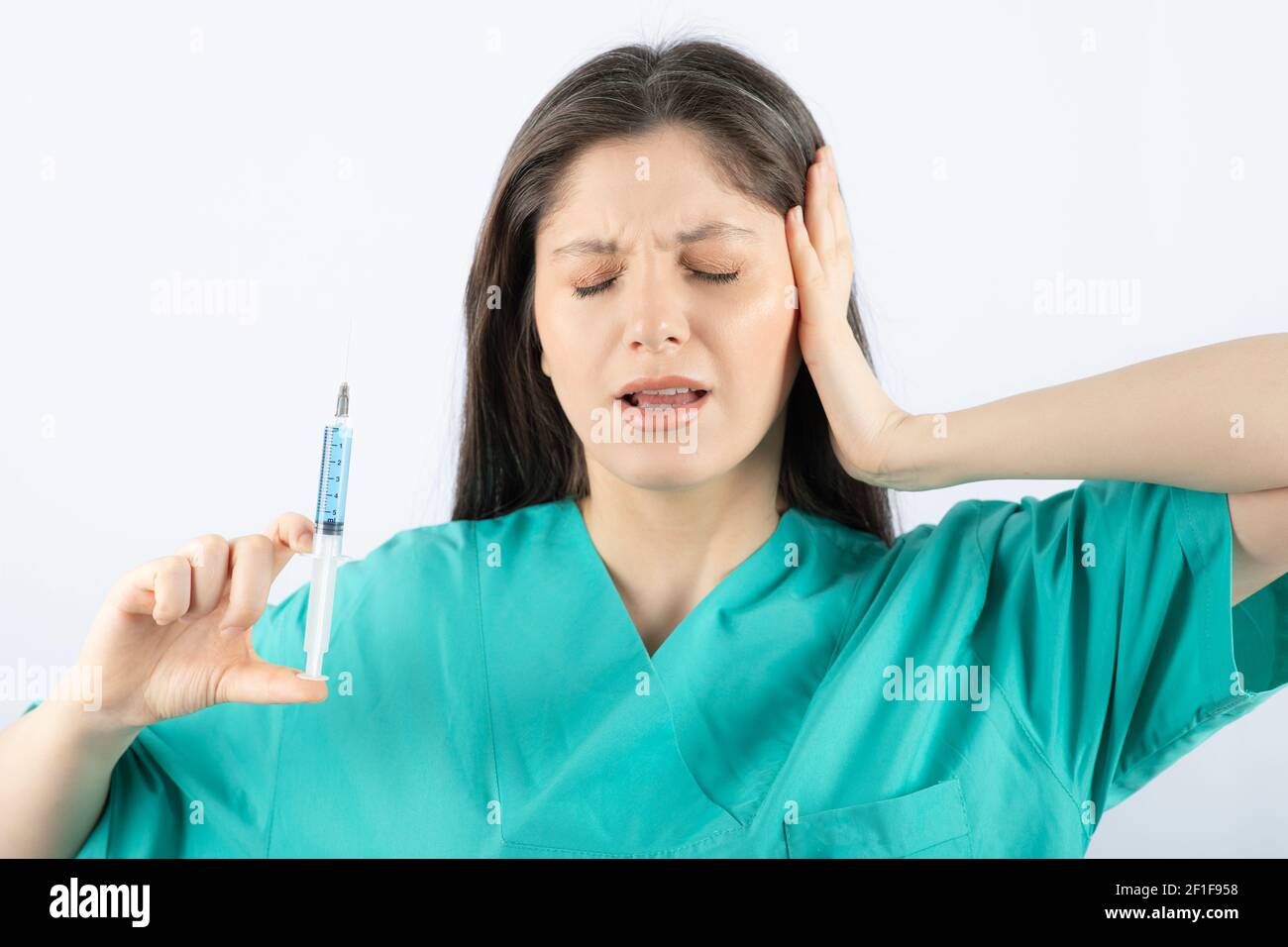 Portrait of female doctor holding a large syringe Stock Photo - Alamy