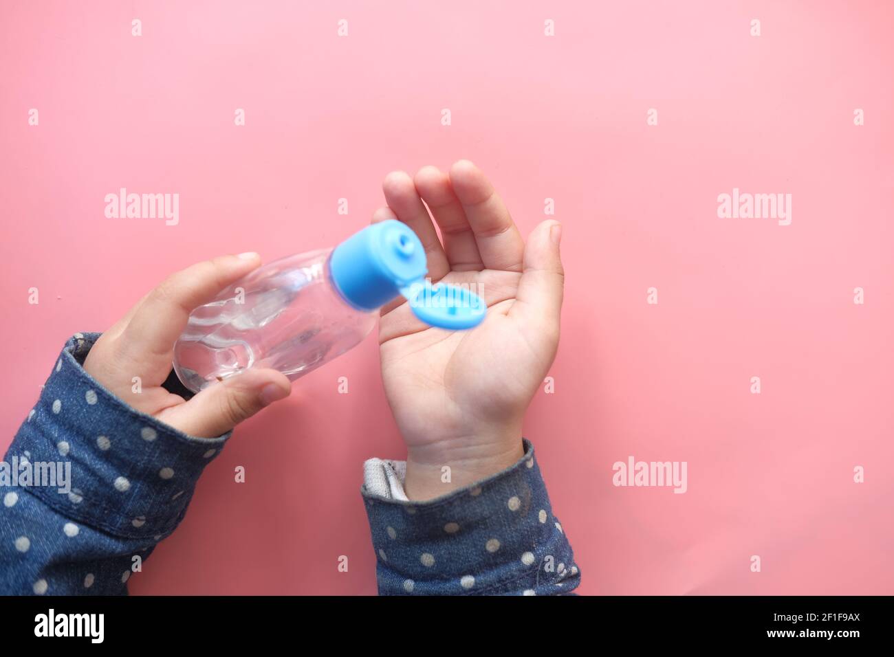 child hand using sanitizer gel for preventing virus with copy space ...