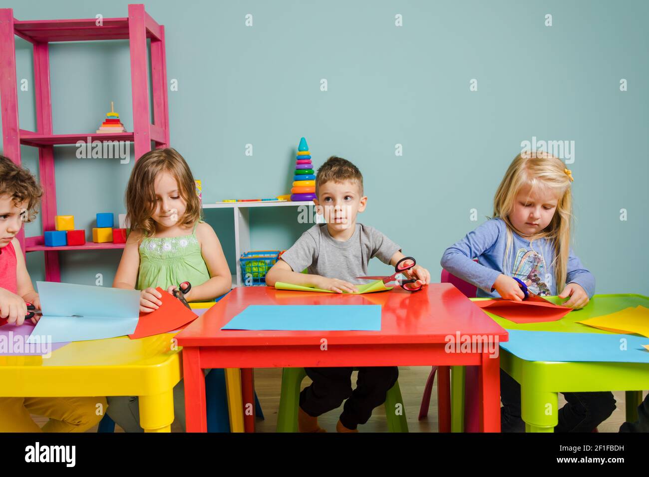 educator and cute preschoolers are making colorful postcards Stock ...