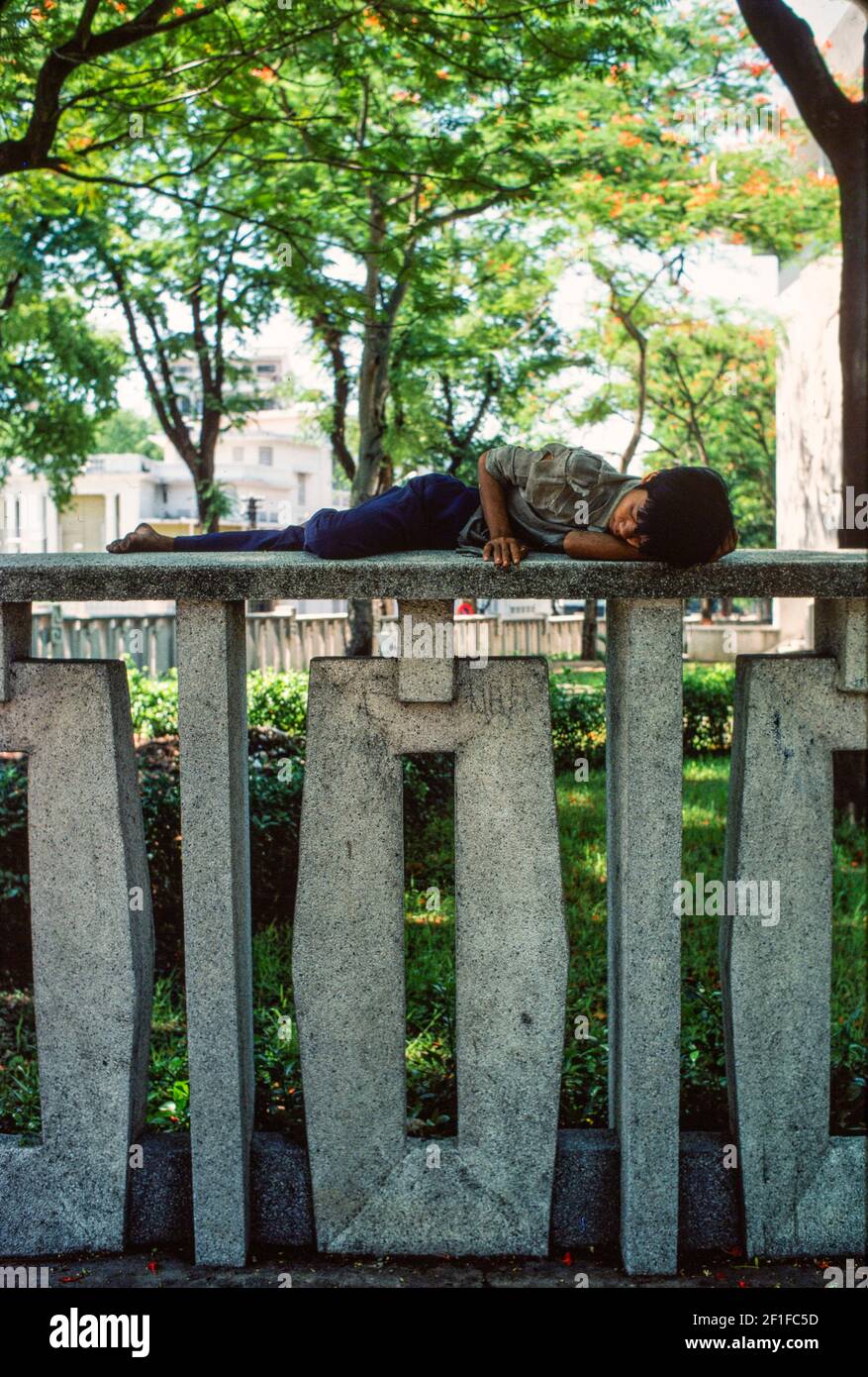 A street boy sleeping during the heat of the day, Hanoi, North Vietnam ...