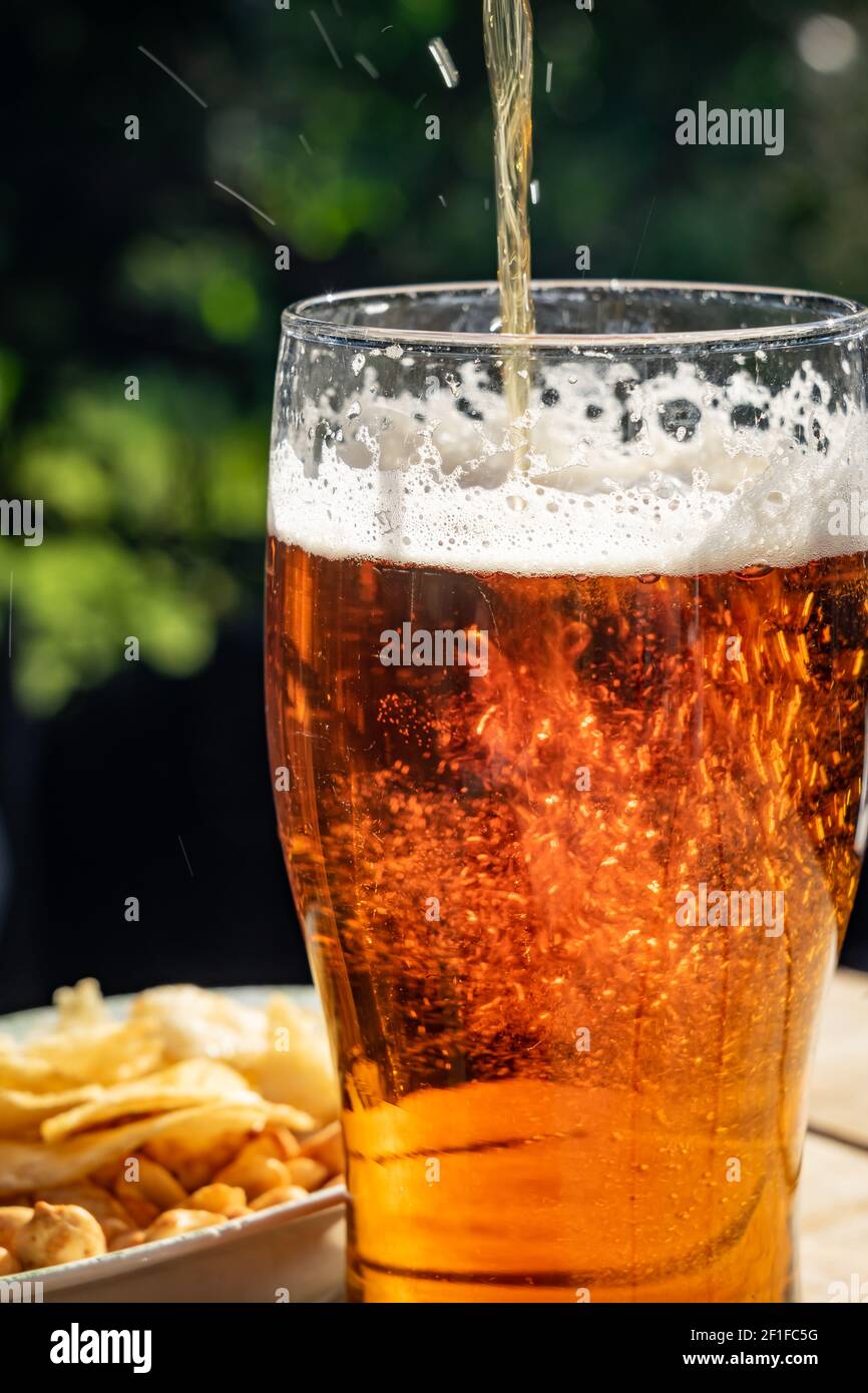 Pouring a refreshing beer in the afternoon sunshine Stock Photo - Alamy