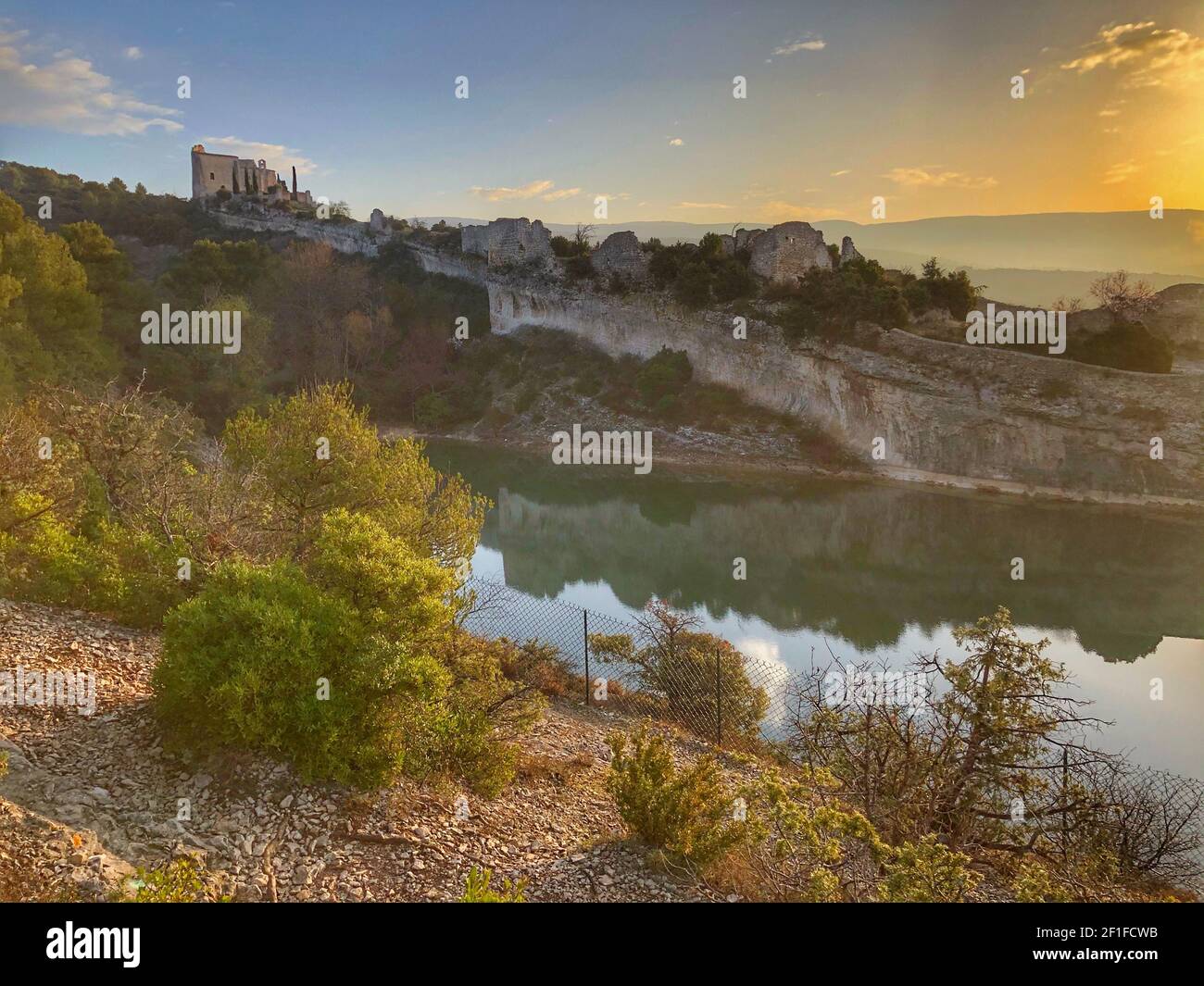 Medieval ruins reflecting in a lake in Provence Stock Photo - Alamy