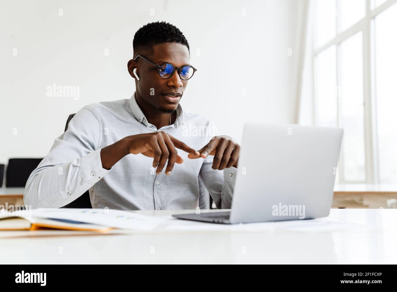 Attractive young dark-skinned businessman wearing formal clothing and ...