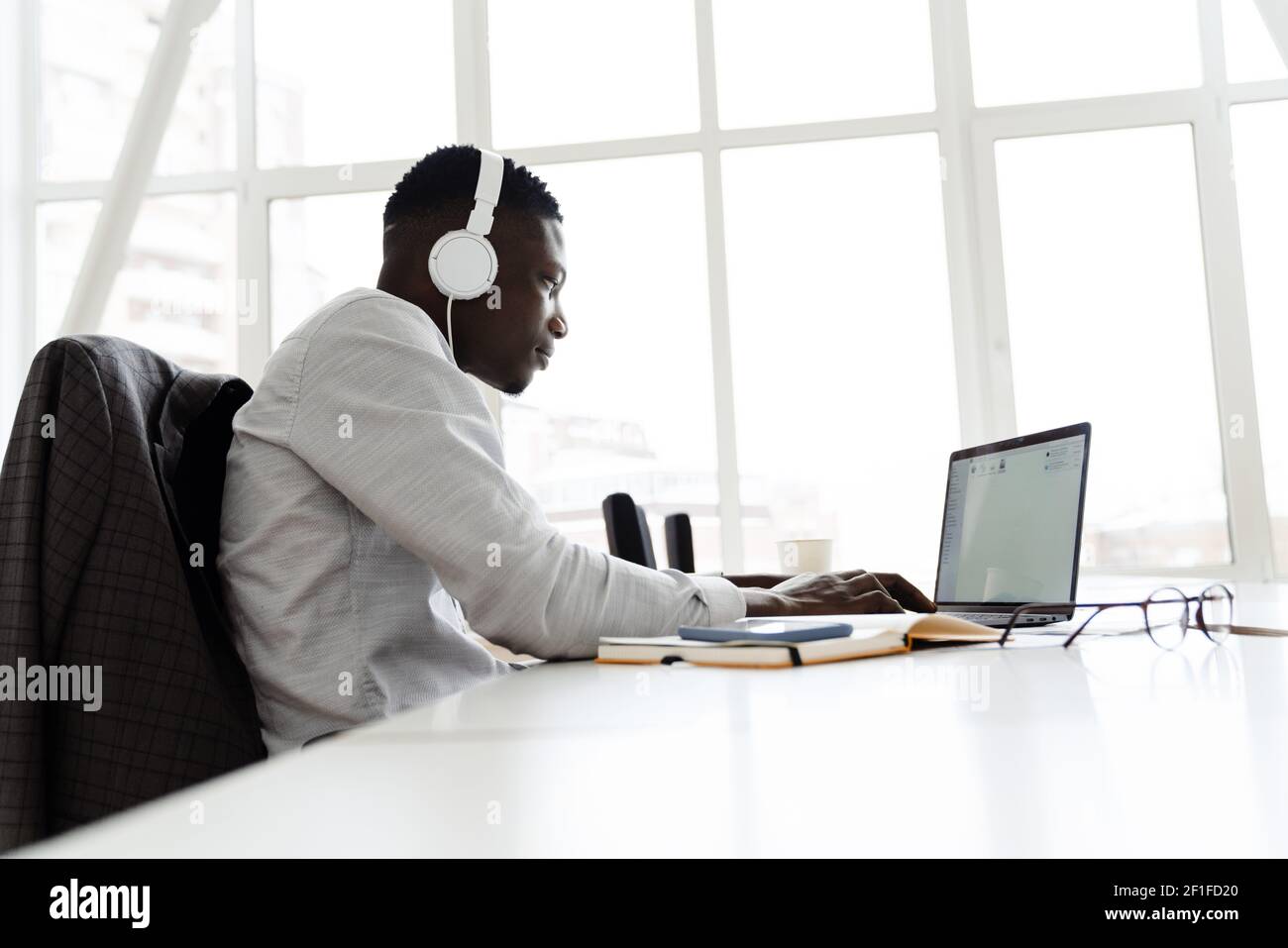 Attractive young dark-skinned businessman wearing formal clothing and ...