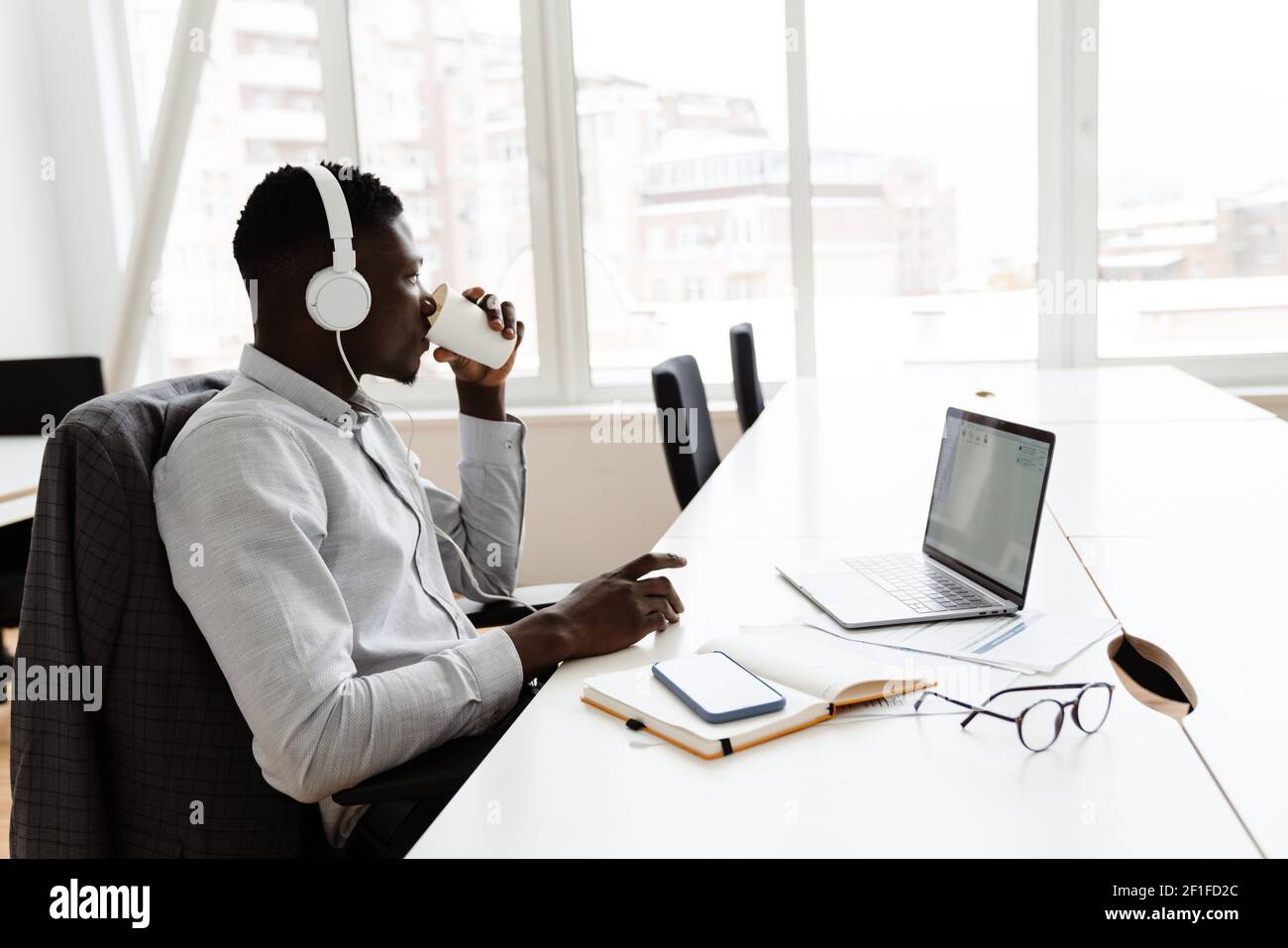 Attractive young dark-skinned businessman wearing formal clothing and ...