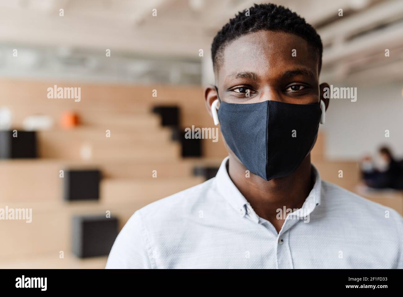 Student wearing mask during covid-19 standing inside classroom Stock ...