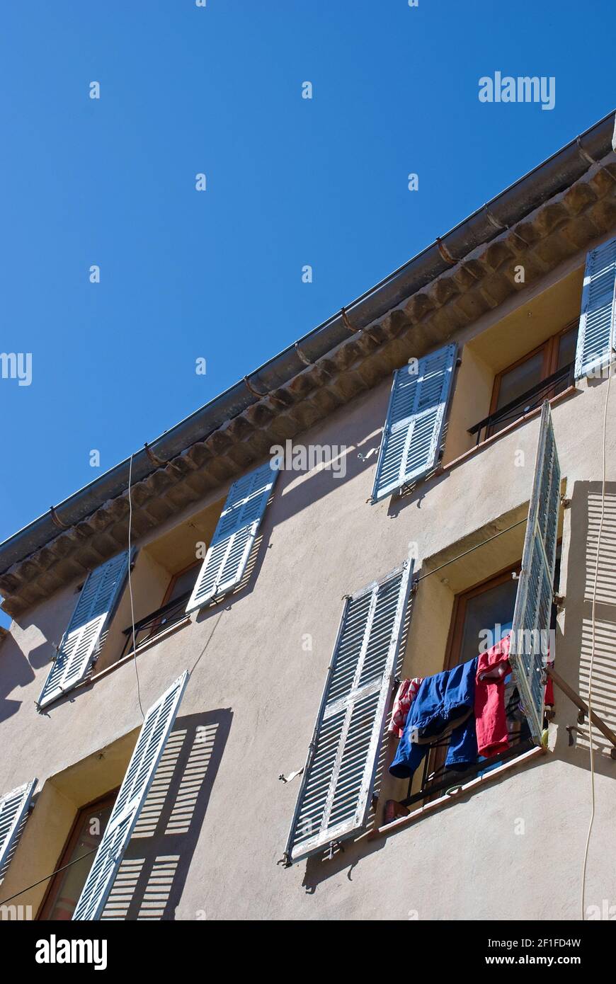 Ventilate properly, windows with blue shutters and laundry to dry Stock ...