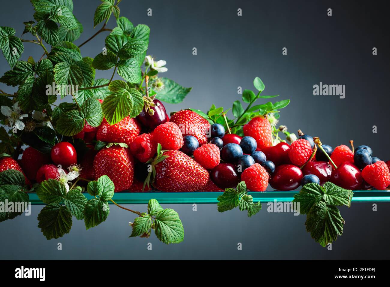 A close-up colorful assorted mix of strawberry, blueberry, raspberry ...
