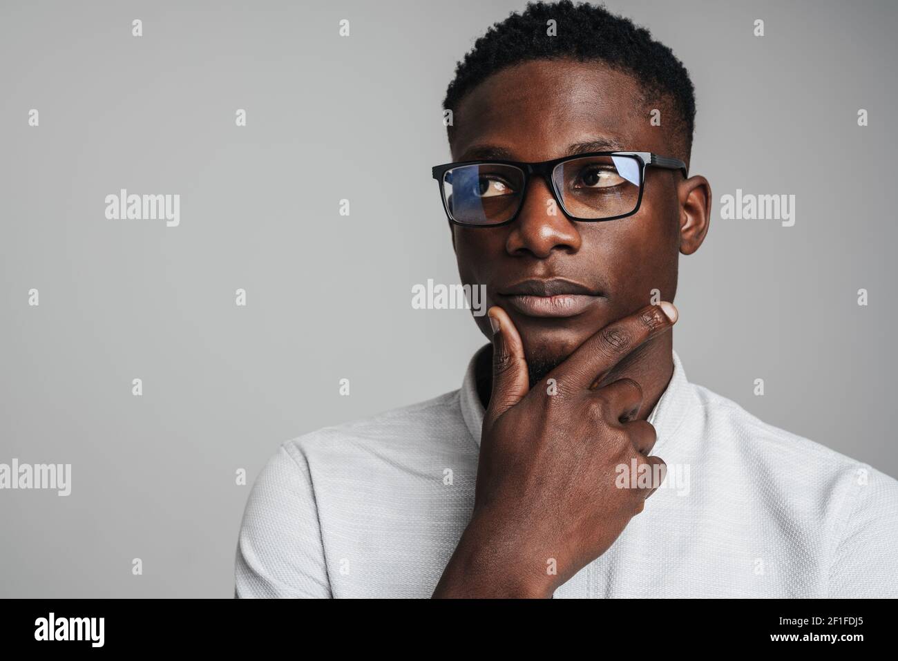 Closeup portrait of young african man thinking deeply about something ...