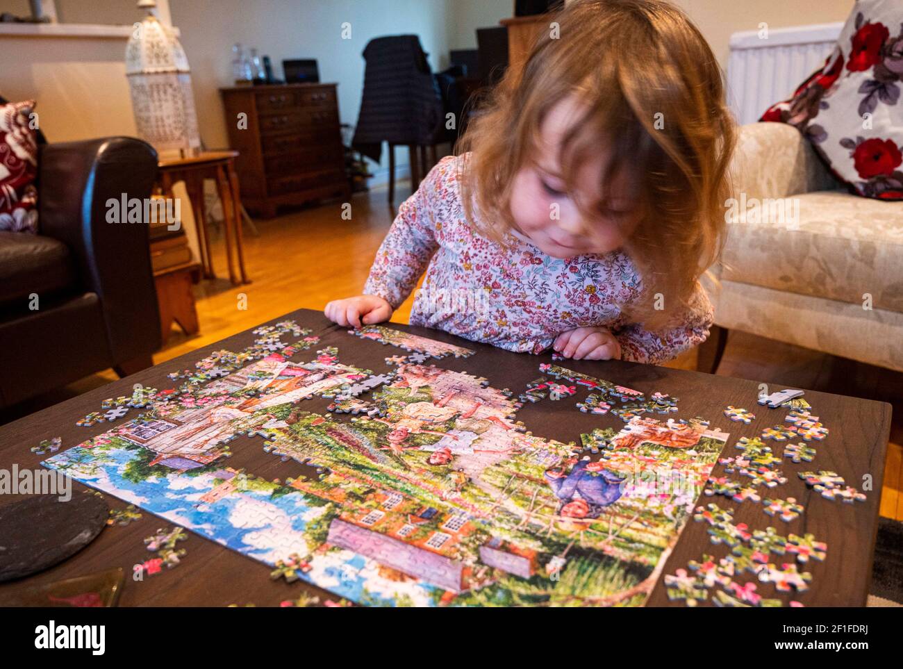Children doing puzzle at table hi-res stock photography and images - Alamy