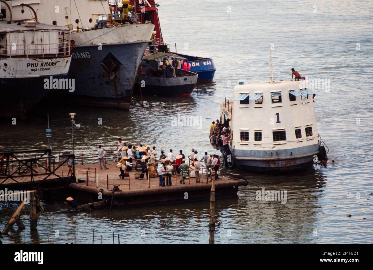 A ferry about to dock after crossing the Siagon River, Ho Chi Minh City ...