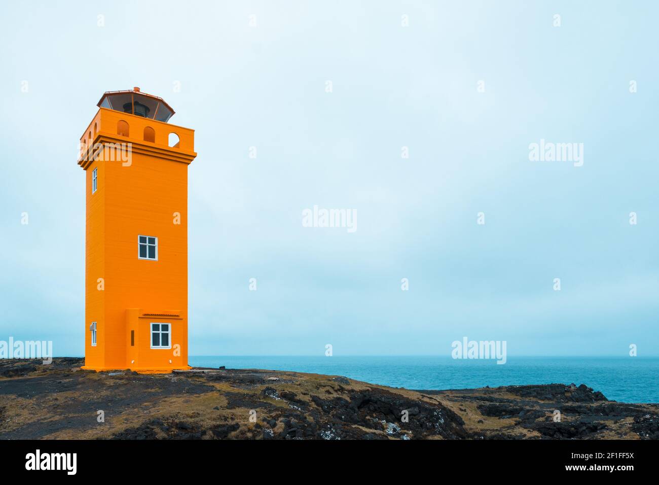 Teal and orange mood of Saxholsbjarg lighthouse in Iceland Stock Photo ...