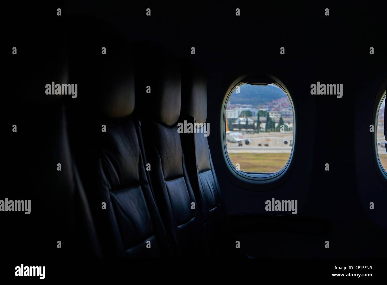 Dark airplane interior. Three free seats by the window. Airplane Before ...