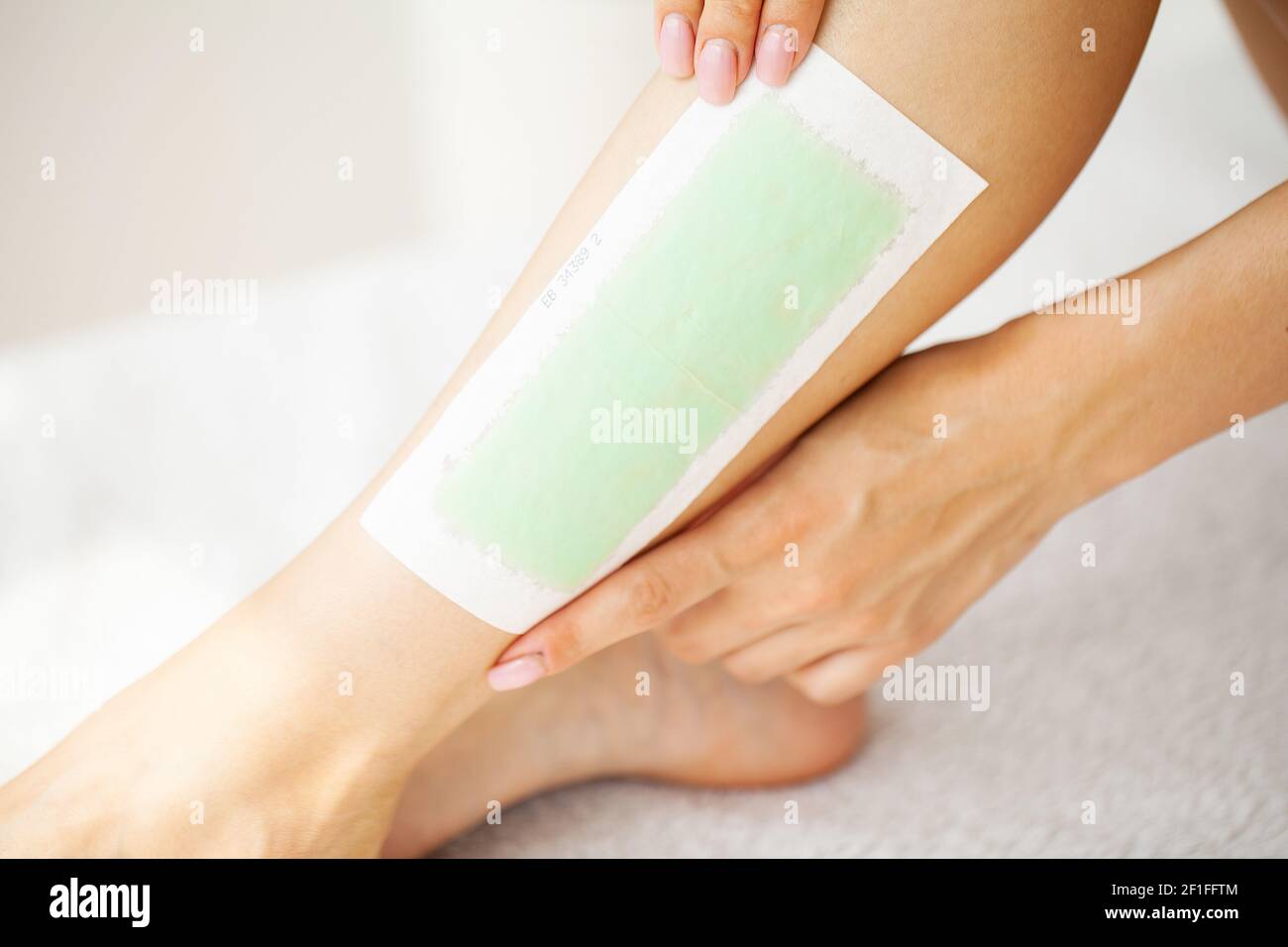 Depilation procedure with wax on the legs Stock Photo - Alamy