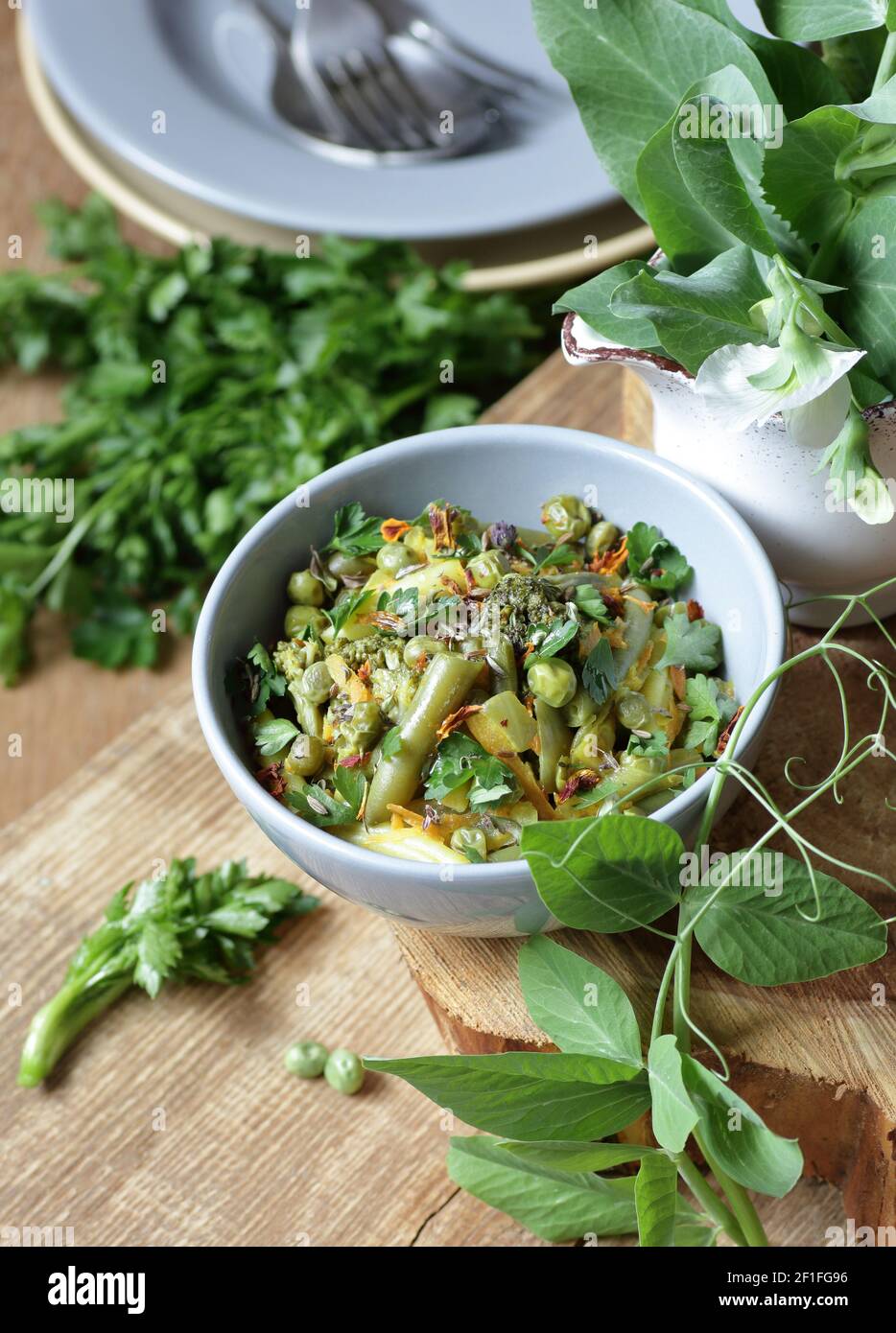 Vegan protein meal, dish of stewed green legume vegetables: peas, green ...