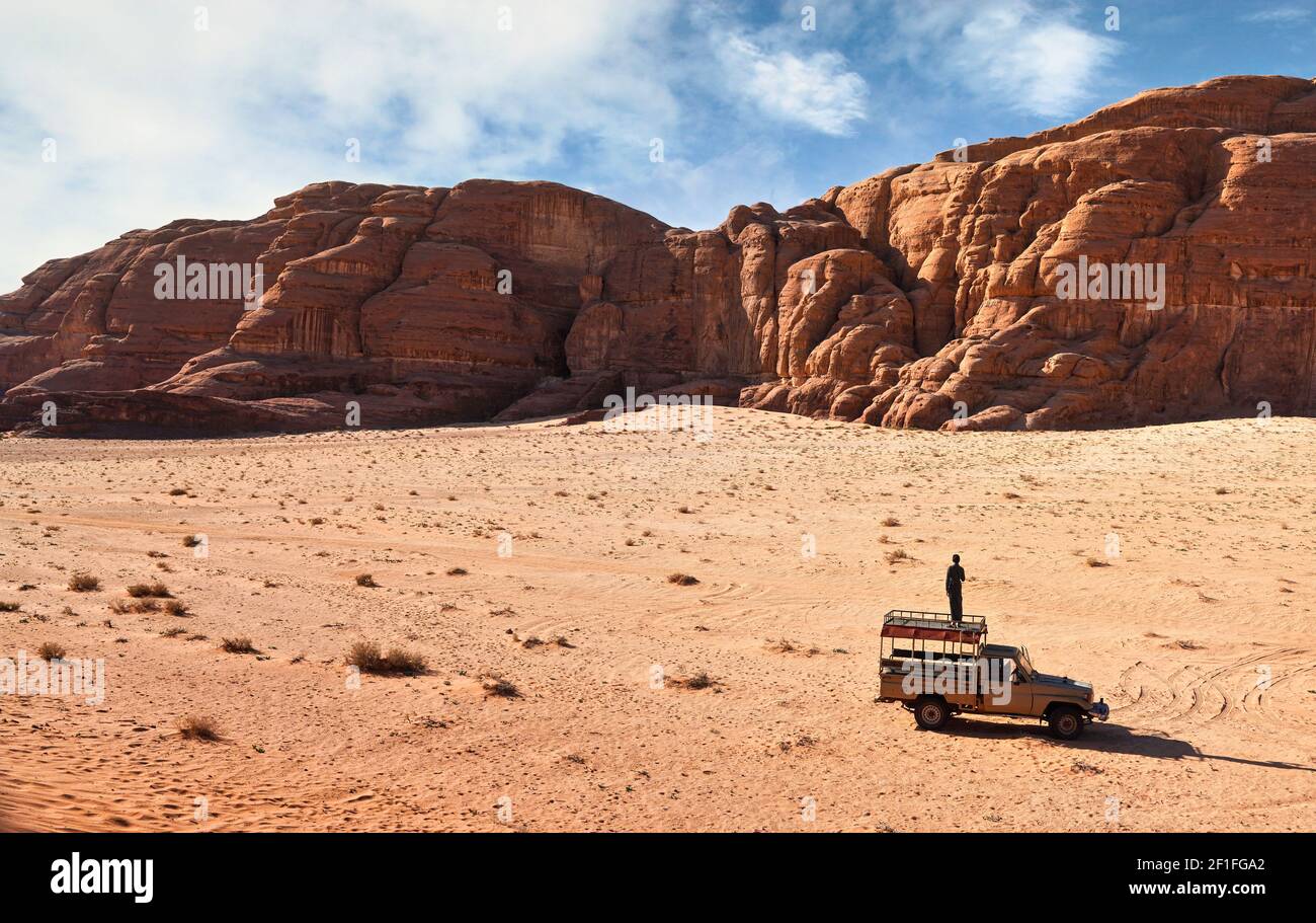 Dusty desert with rocky massif and blue sky above, off road desert ...