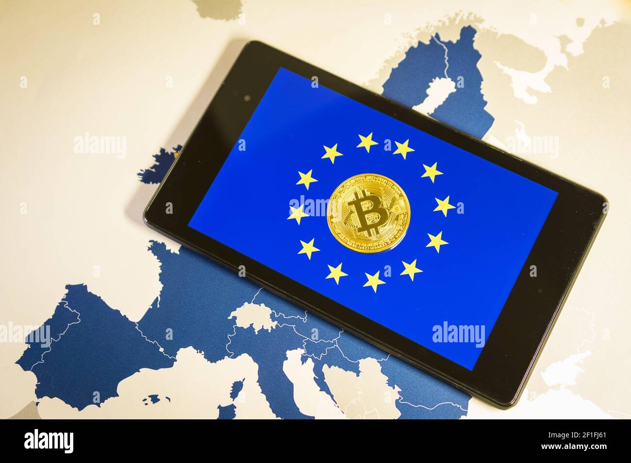 Financial concept with golden Bitcoin over smartphone, EU flag and map ...