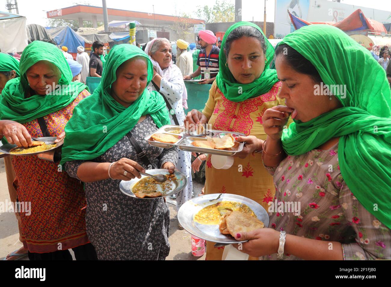 Indian woman farmers seen eating food at the protest site of Tikri ...