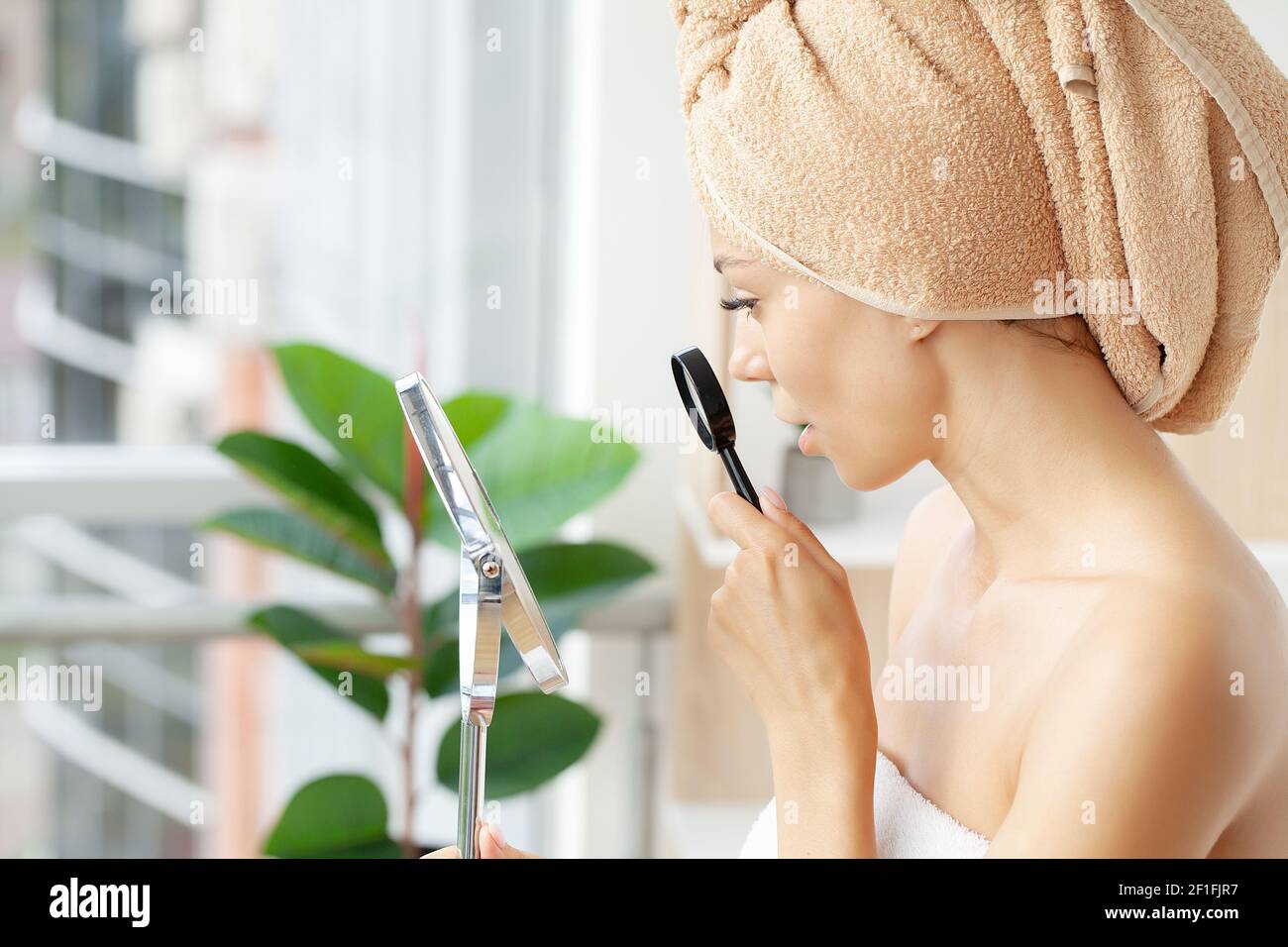 Teen girl with problem skin look at pimple with magnifying glass Stock ...