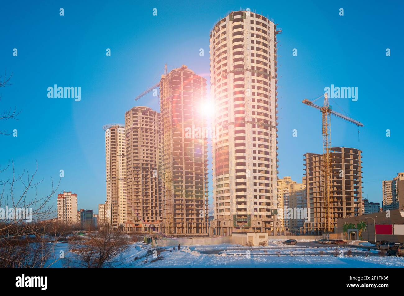 Construction site with unfinished multi apartment buildings and cranes ...