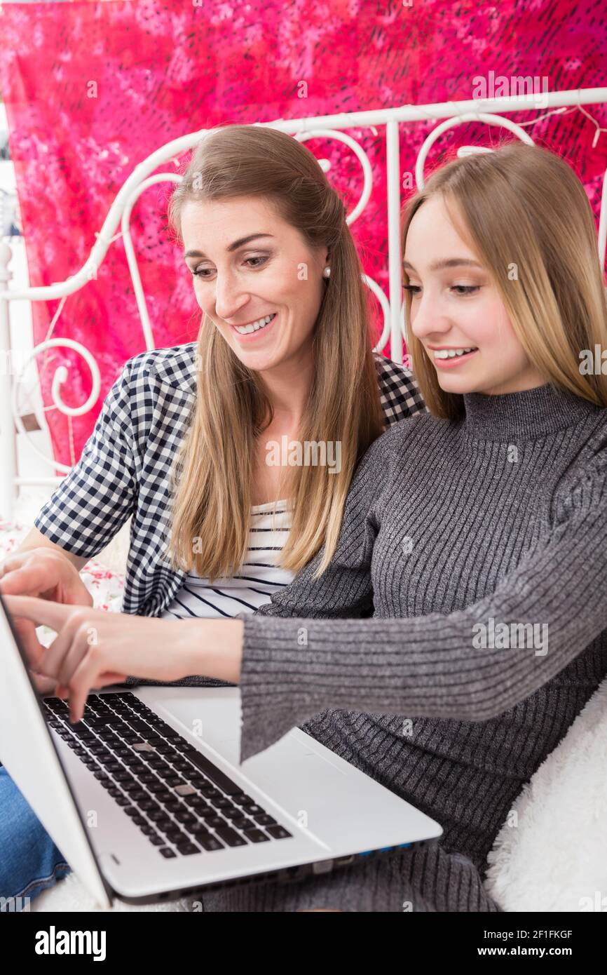 Mother and daughter having fun on the computer Stock Photo - Alamy