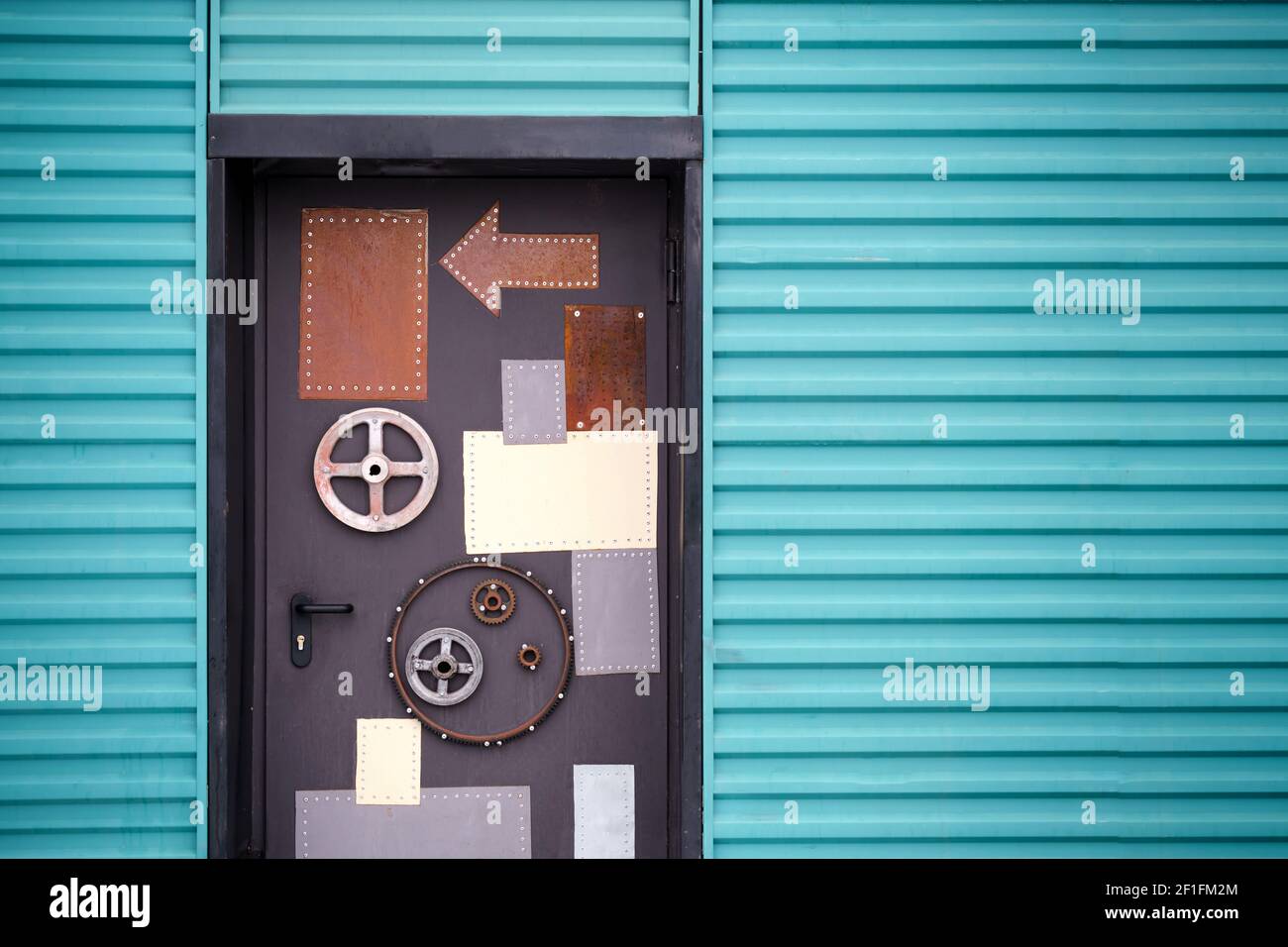 Steampunk handmade door to the workshop. Entrance with arrows and ...