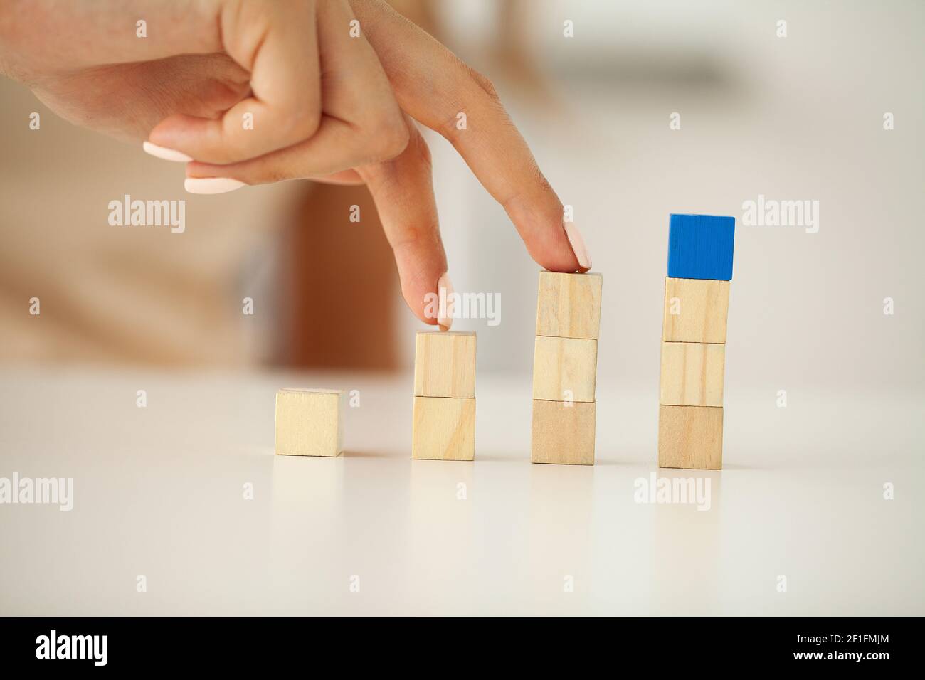 Woman hand putting and stacking blank wooden cubes on desk with copy ...