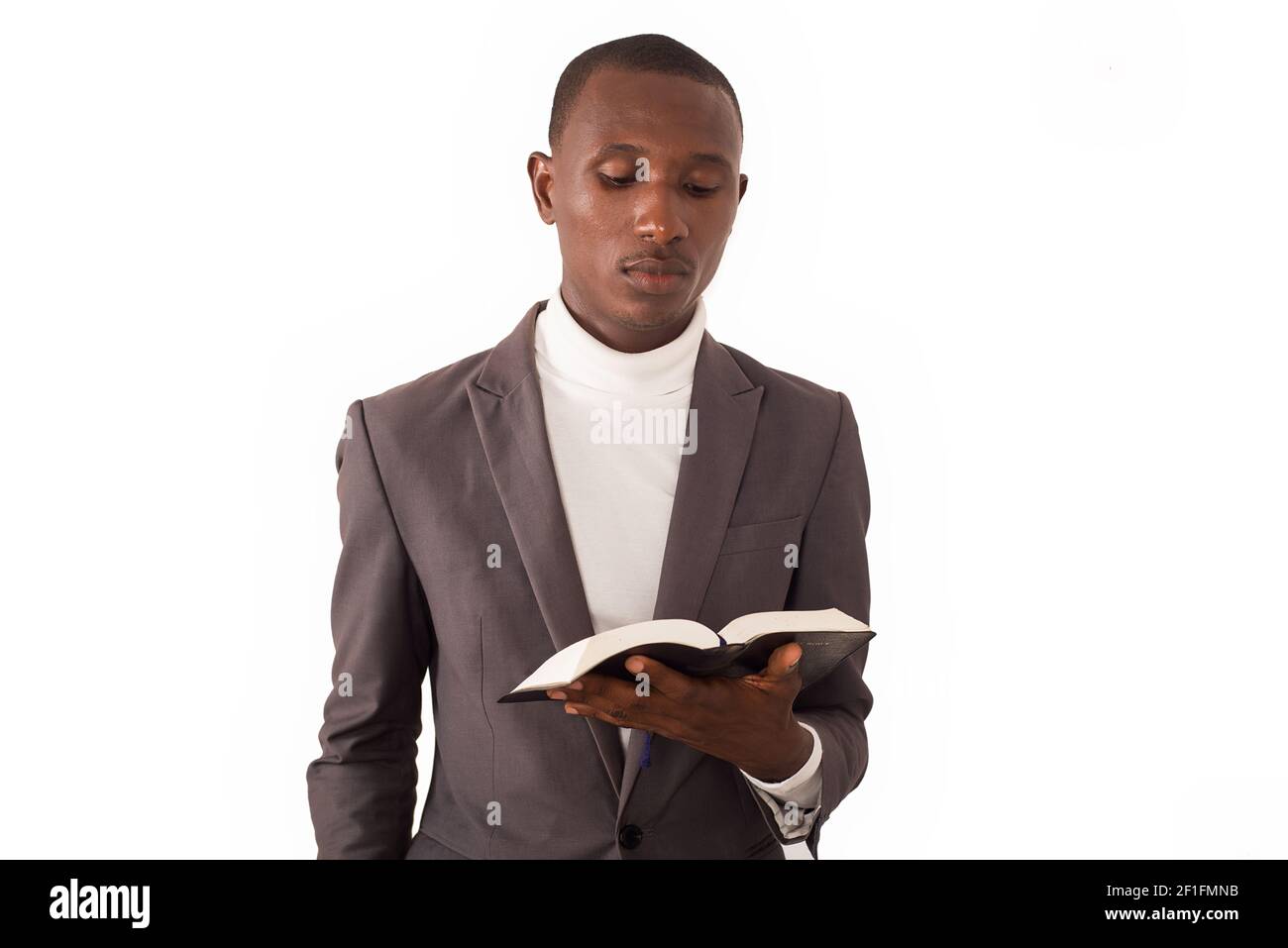 portrait of young pastor standing and reading a Bible in his hand Stock ...