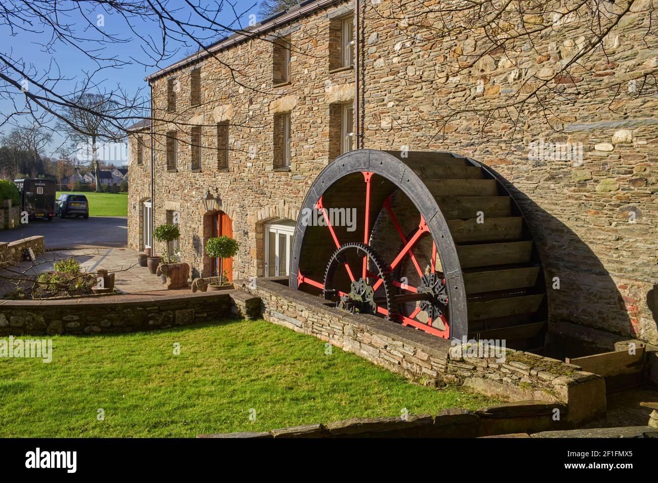 Very large waterwheel on the side of a house that was once a mill in ...