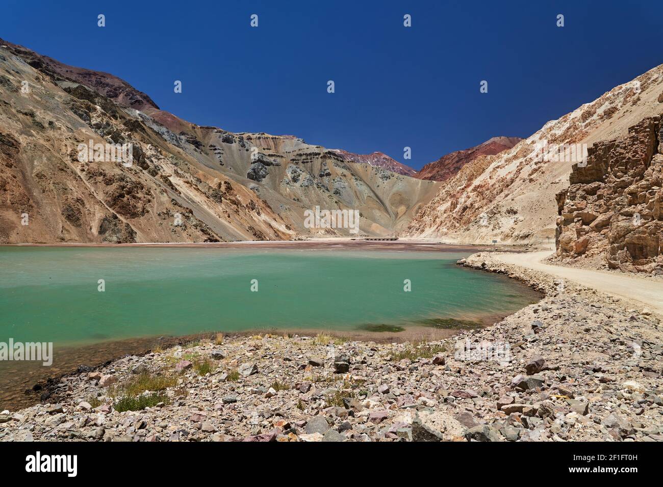 beautiful emerald lake in a dry and arid desolation in the high andes ...
