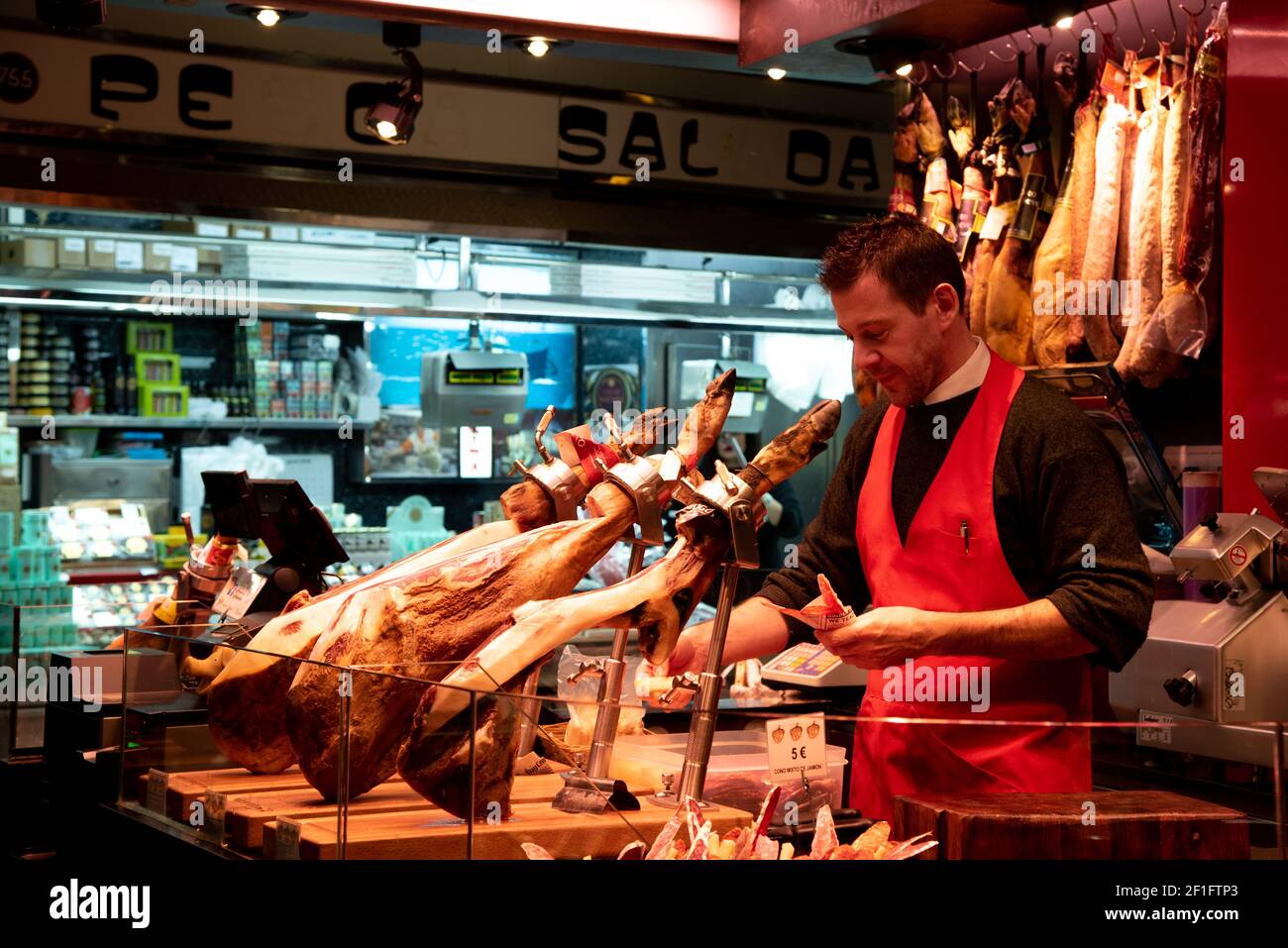 Bucher at a meat farmer market counter. Various meat slices at a ...