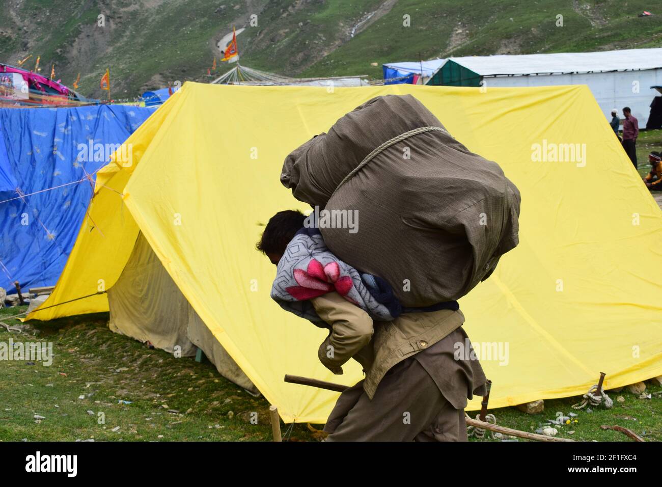 A female carrying a large pack on her pack Stock Photo - Alamy