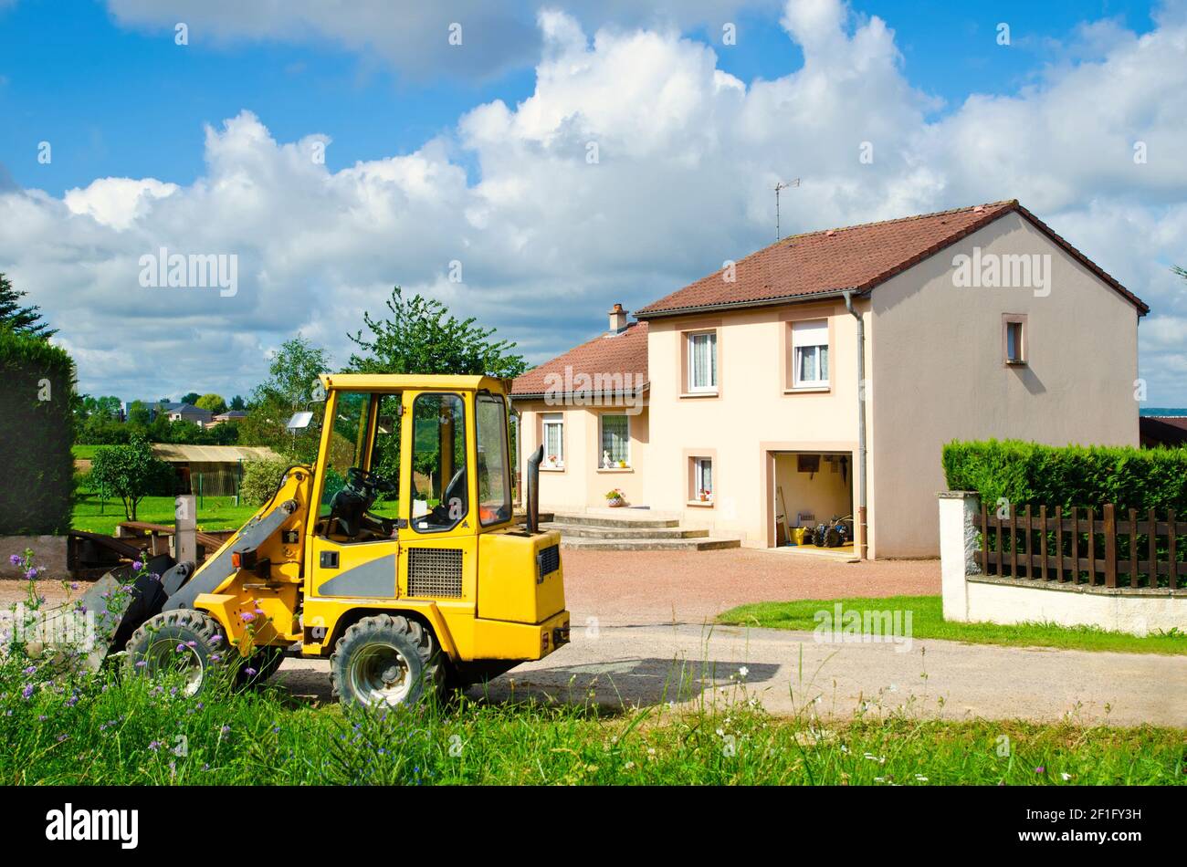 rural scene of tractor near house Stock Photo - Alamy