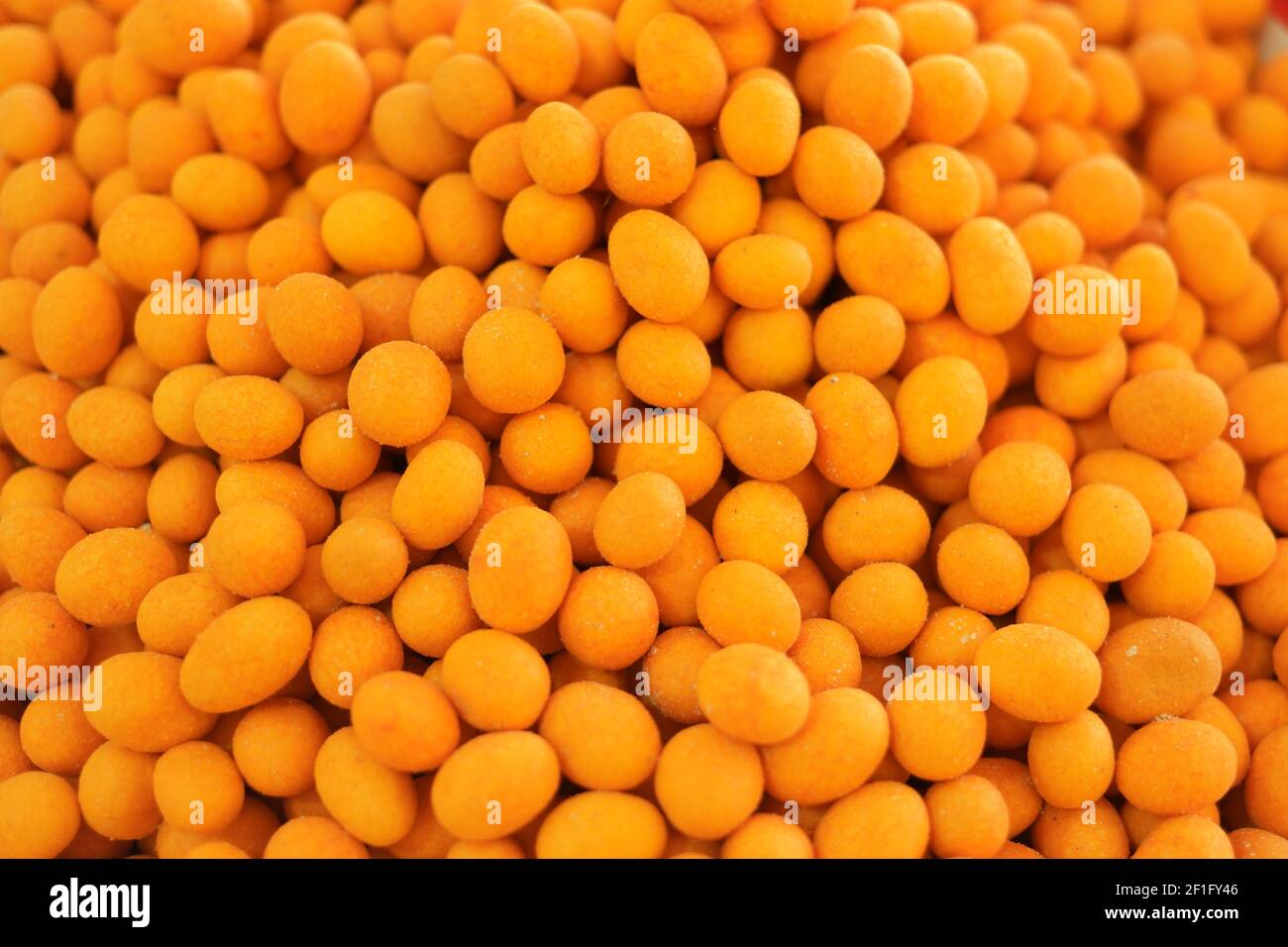Crispy coated peanuts background Stock Photo - Alamy