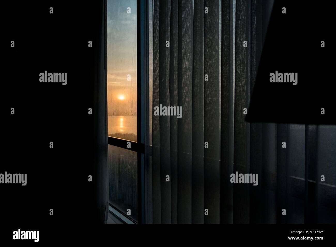 A view of a beautiful sunset through a window Stock Photo - Alamy