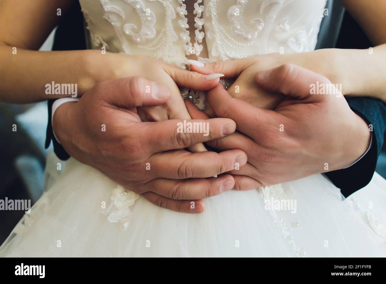 Hugs. Men's arm around the woman's waist. Lovers in the arms. Man ...
