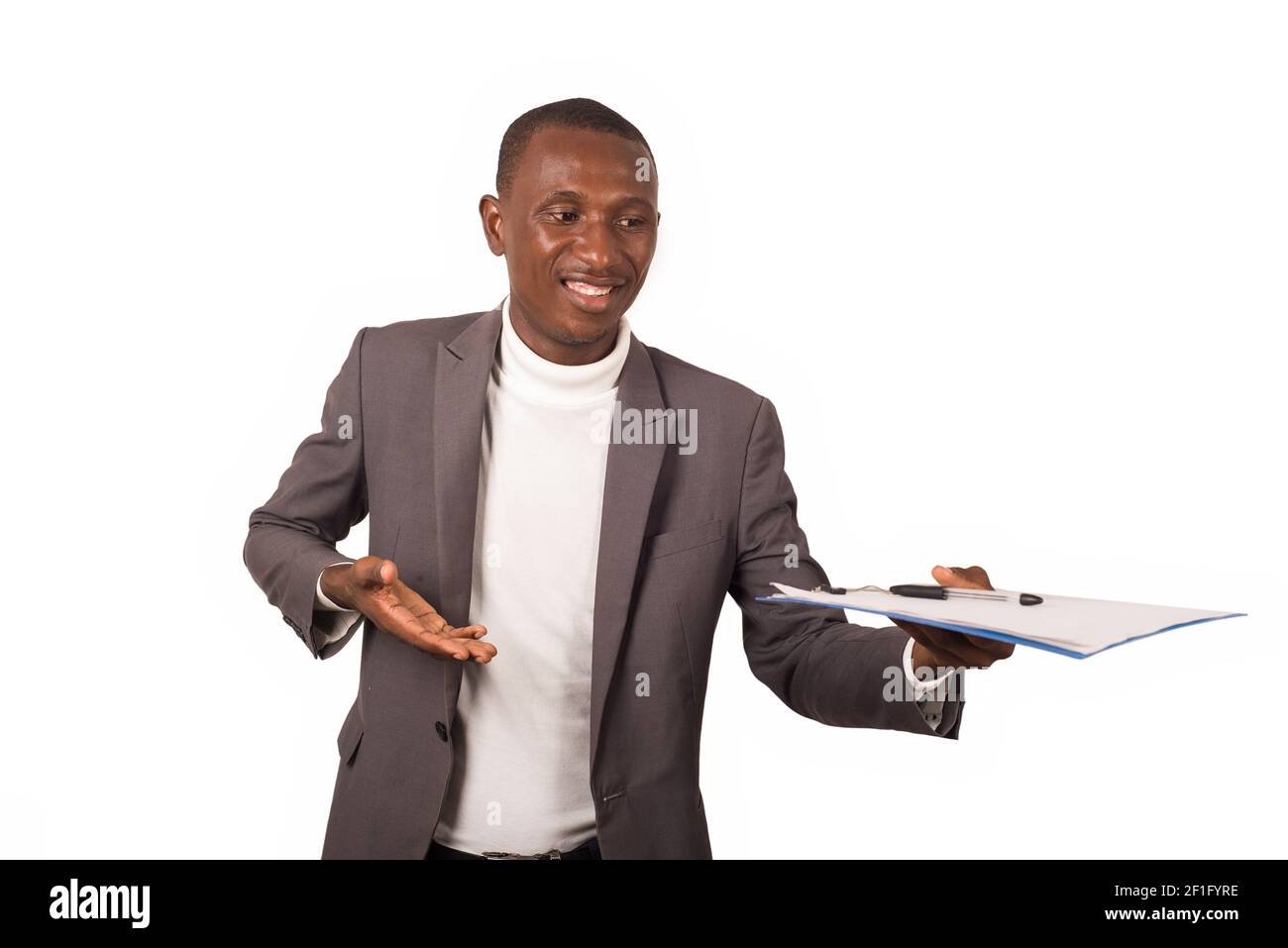 Portrait of young smiling man in suit standing on white background ...