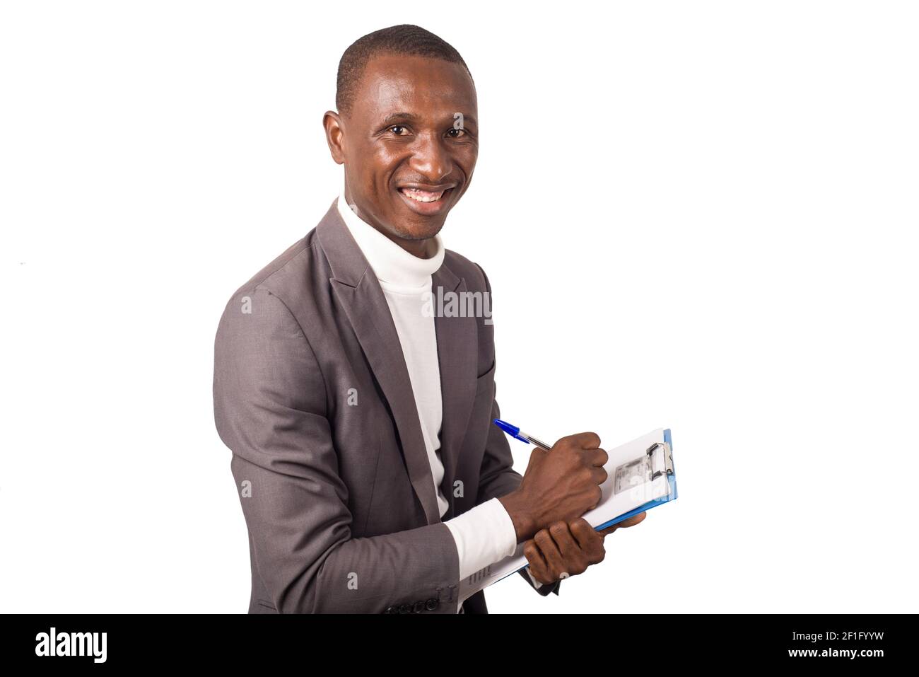 young smiling man standing takes notes isolated on white background ...