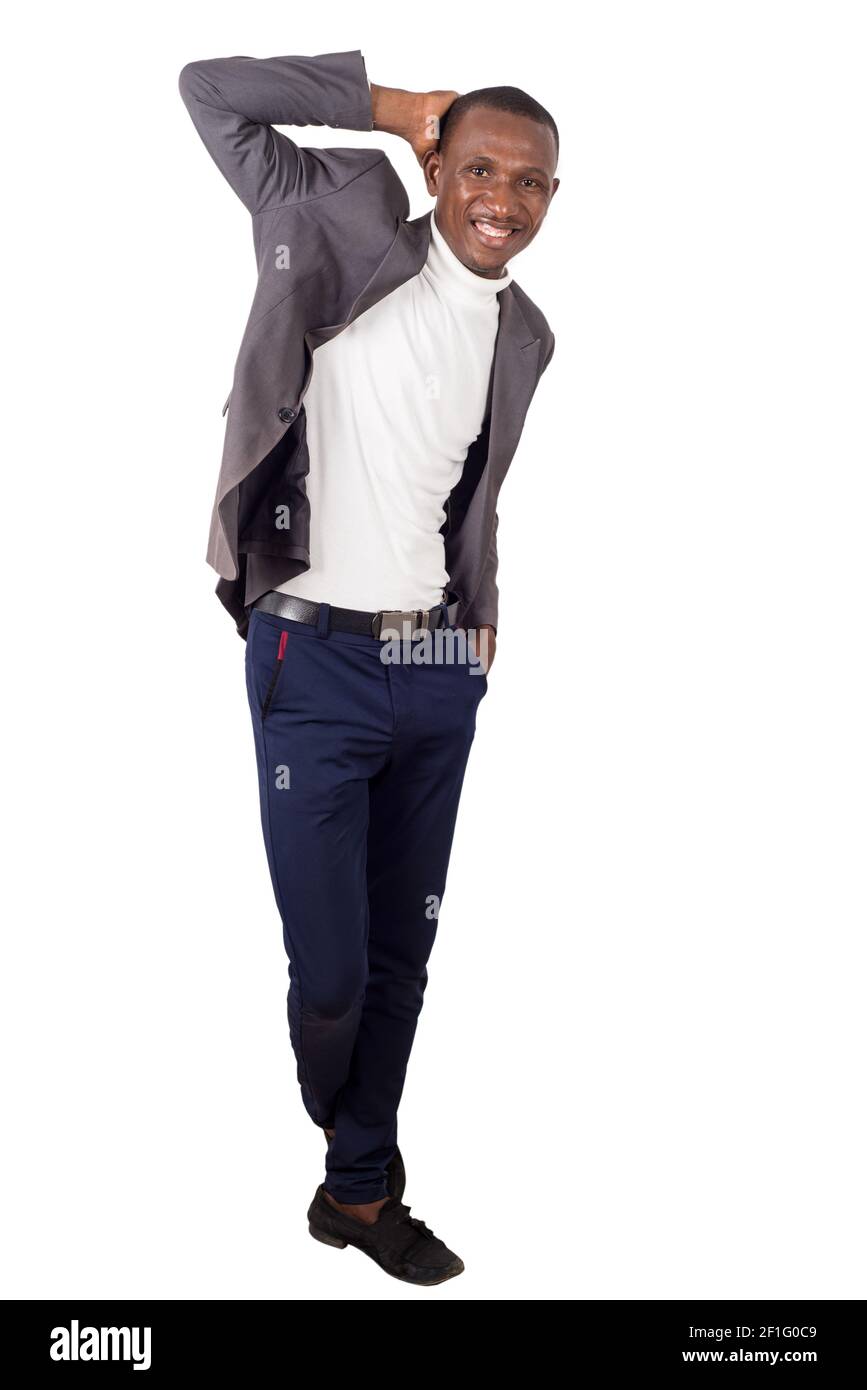 young smiling man standing with crossed feet hand on the nape isolated ...