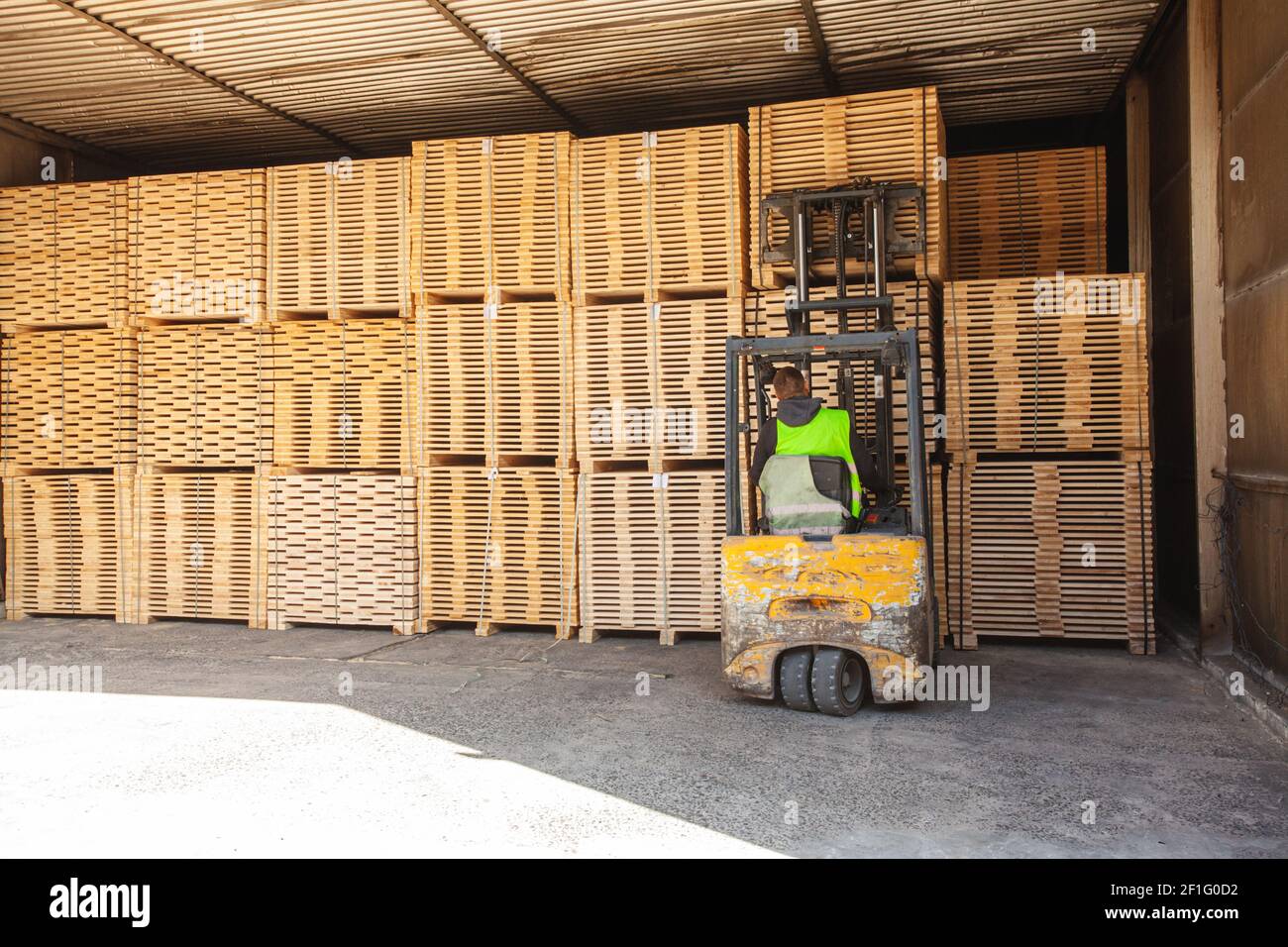 The old forklift load lumber into dry warehouse Stock Photo - Alamy