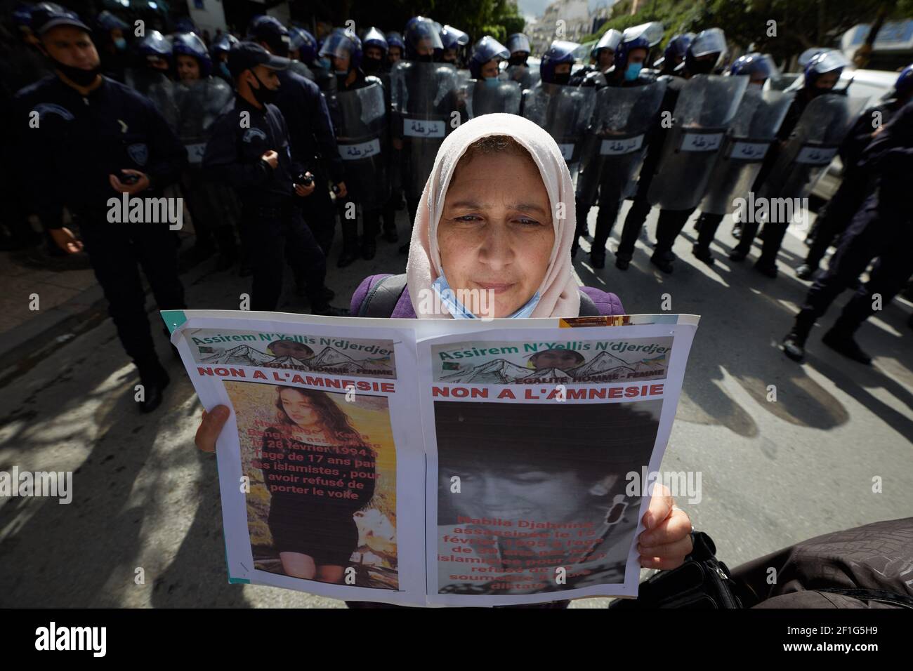 Protesters carry banners as they march during a protest marking ...