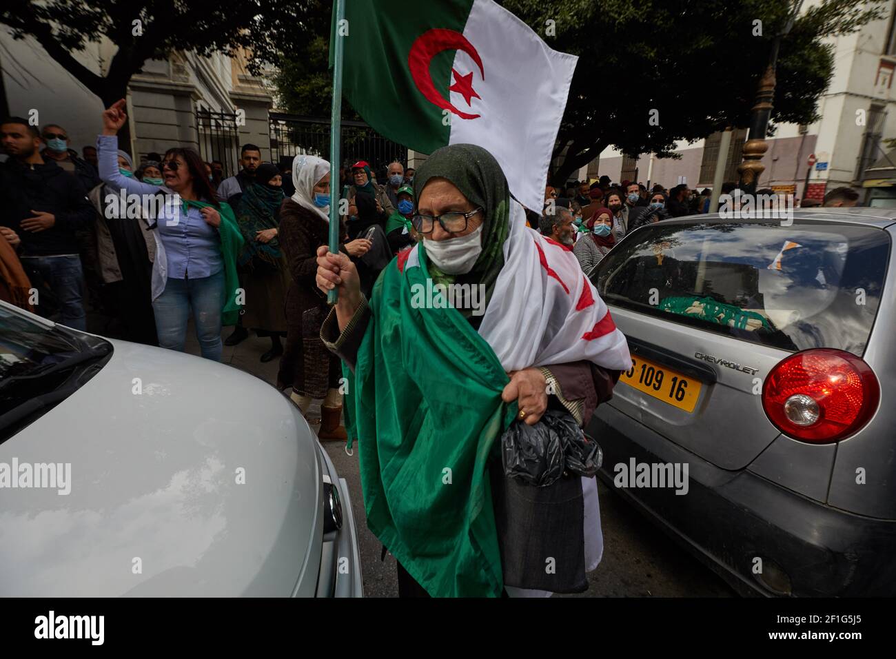Protesters carry banners as they march during a protest marking ...