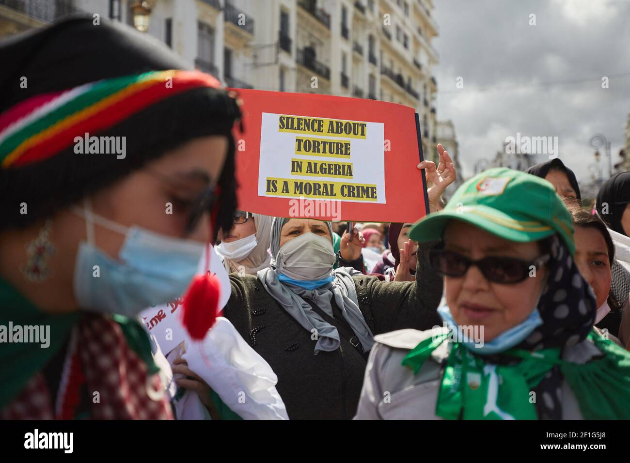Protesters carry banners as they march during a protest marking ...