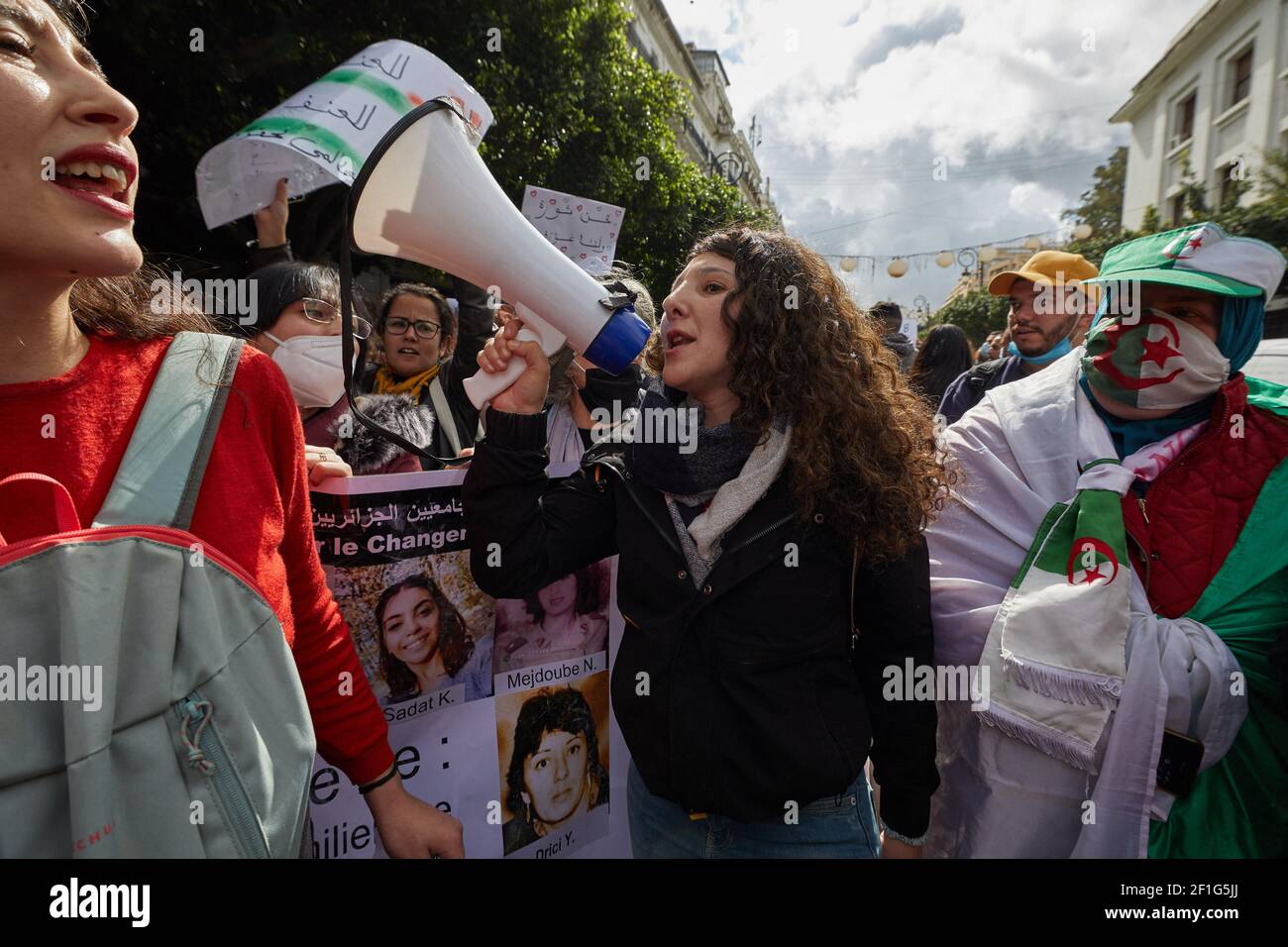 Protesters carry banners as they march during a protest marking ...