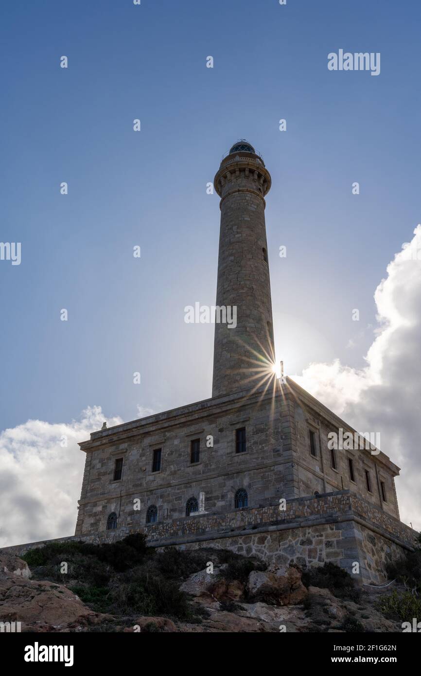 A vertical close up view of the Cape Palos lighthouse in Spain with a ...