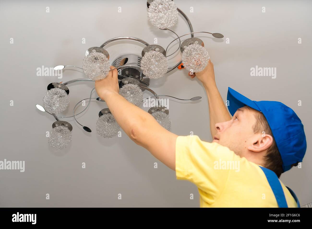 Man hanging chandelier fixture hi-res stock photography and images - Alamy