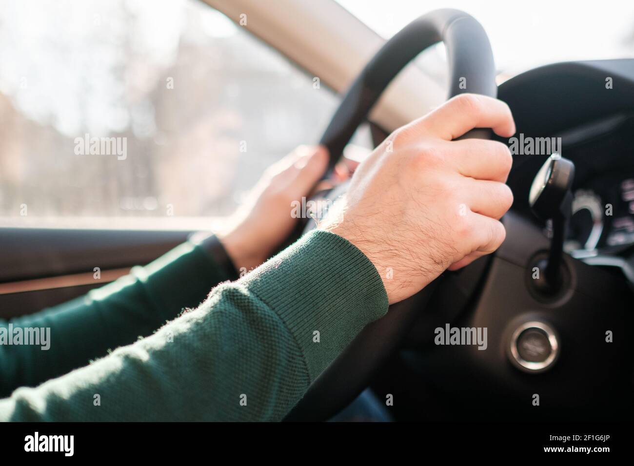 Close up mans hands on the wheel, driving a car Stock Photo - Alamy