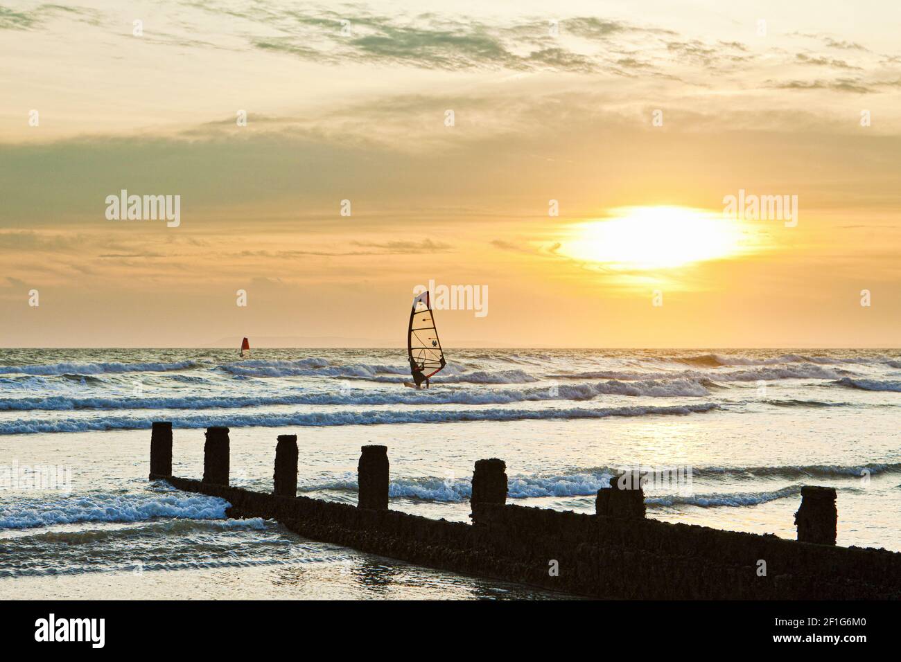 Sunset over the English Channel with windsurfers, viewed from the south ...